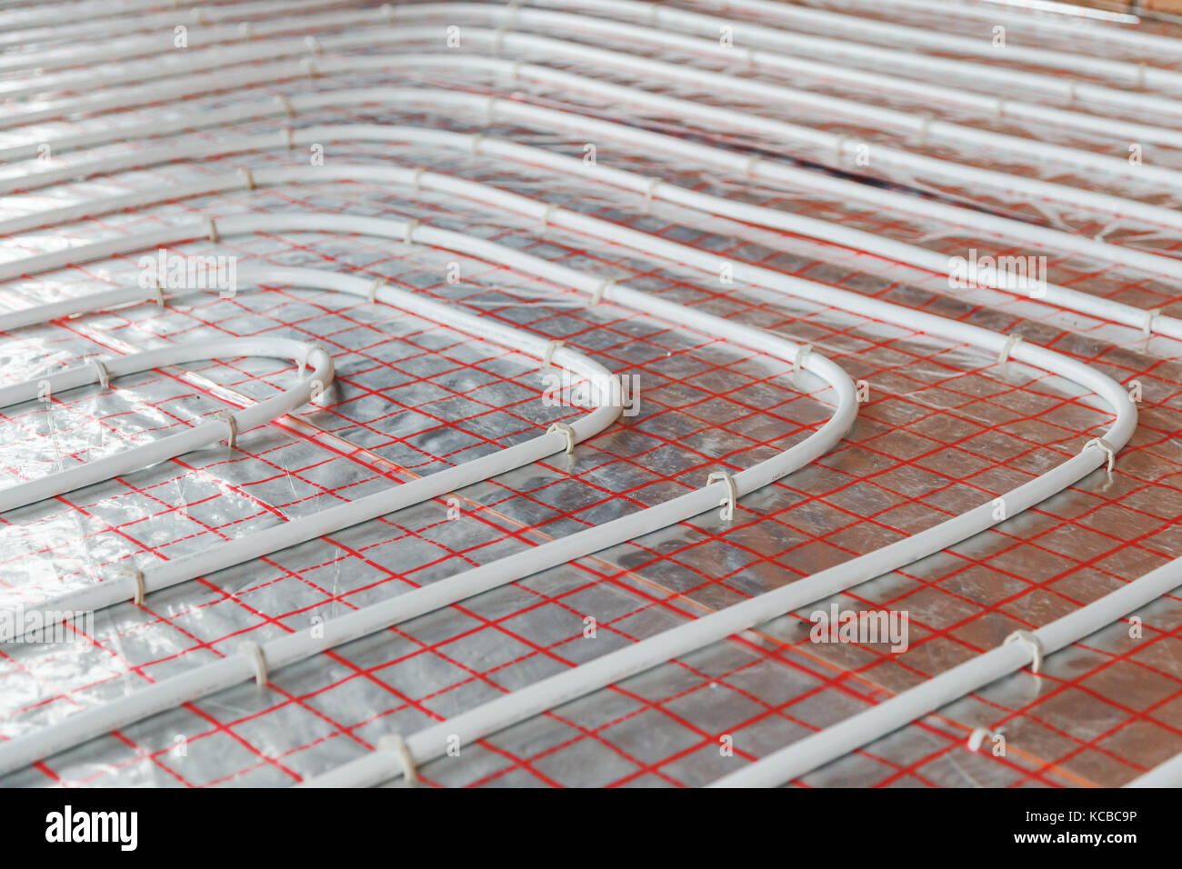 Underfloor heating installation. Close up on water floor heating system ...
