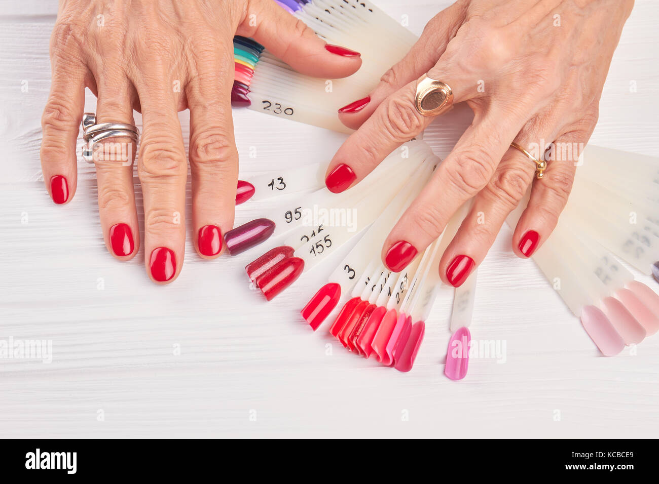Senior woman hands with red manicure Stock Photo - Alamy