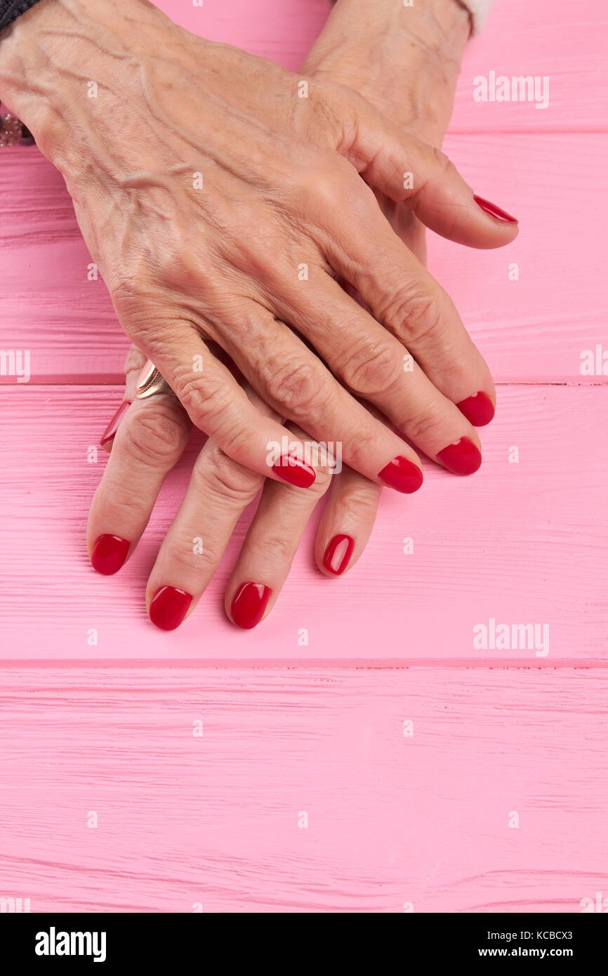 Female manicured hands on wooden background Stock Photo - Alamy