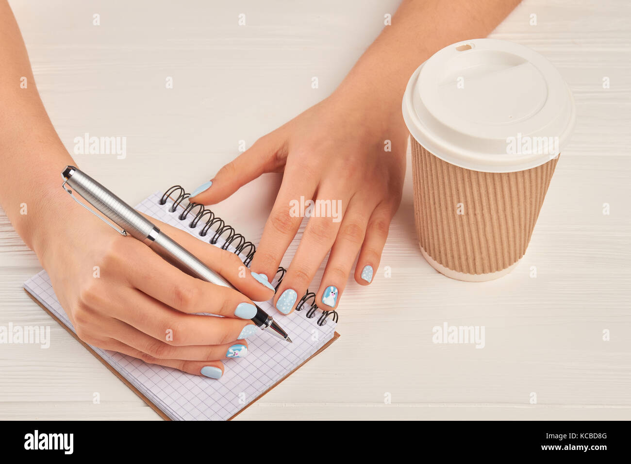 Woman hand writing on notebook Stock Photo - Alamy