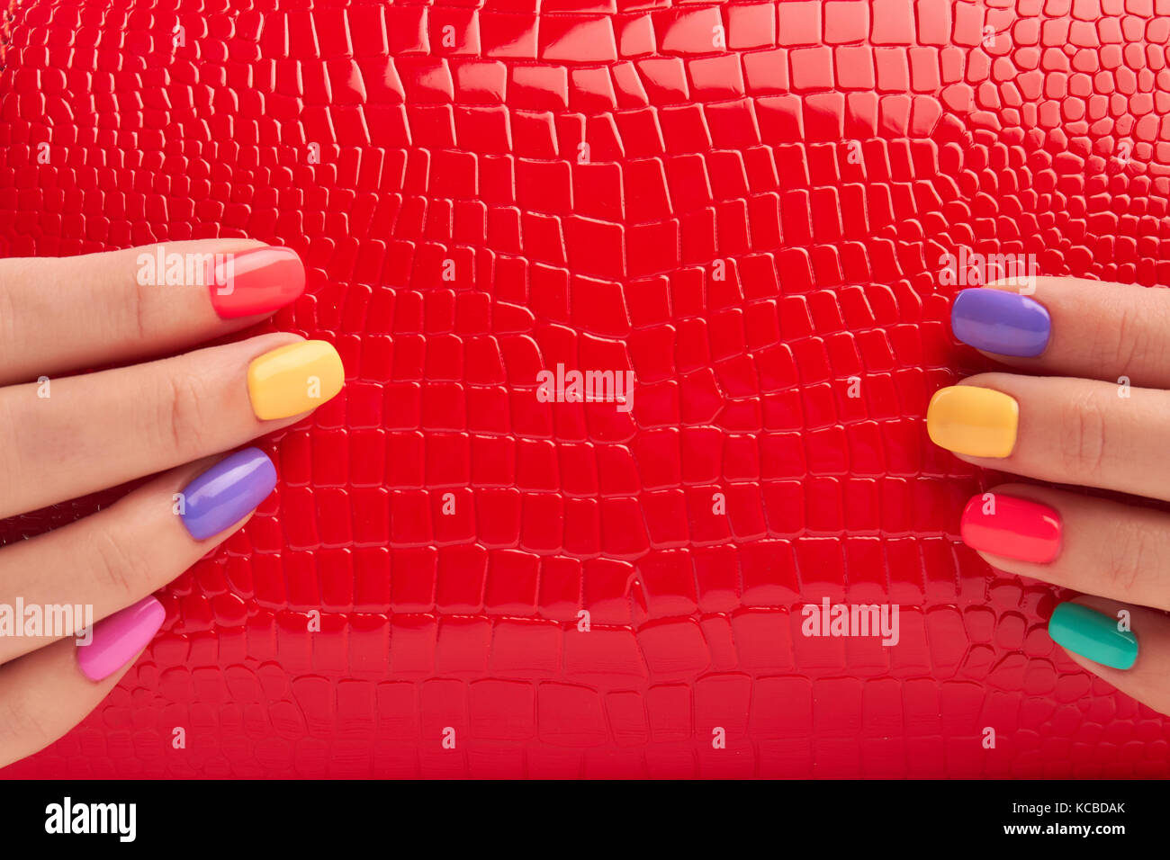Close up red bag in manicured hands Stock Photo - Alamy