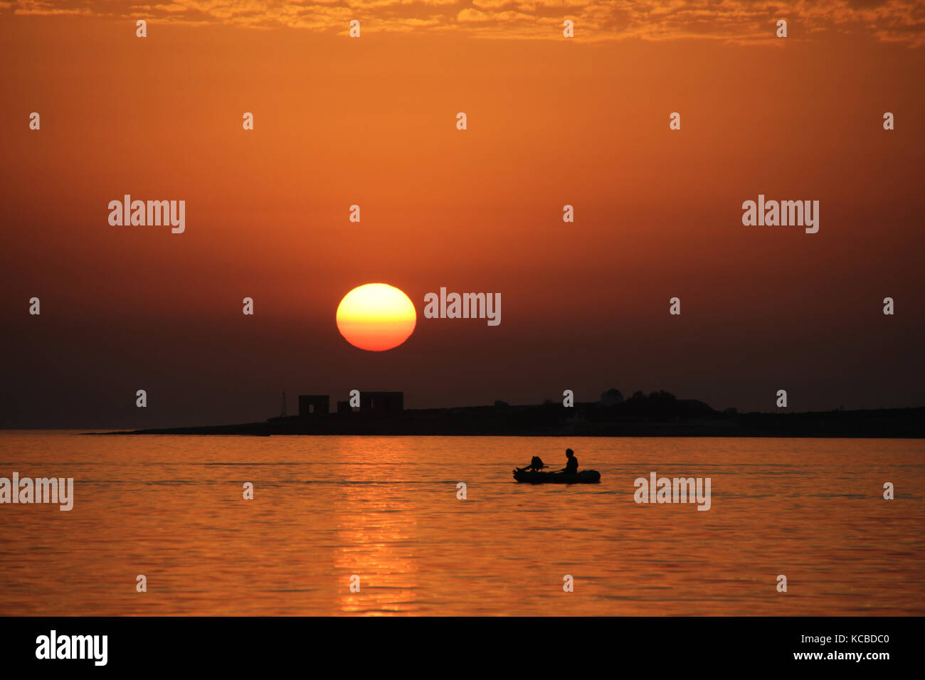 rowing across the sunset Stock Photo - Alamy