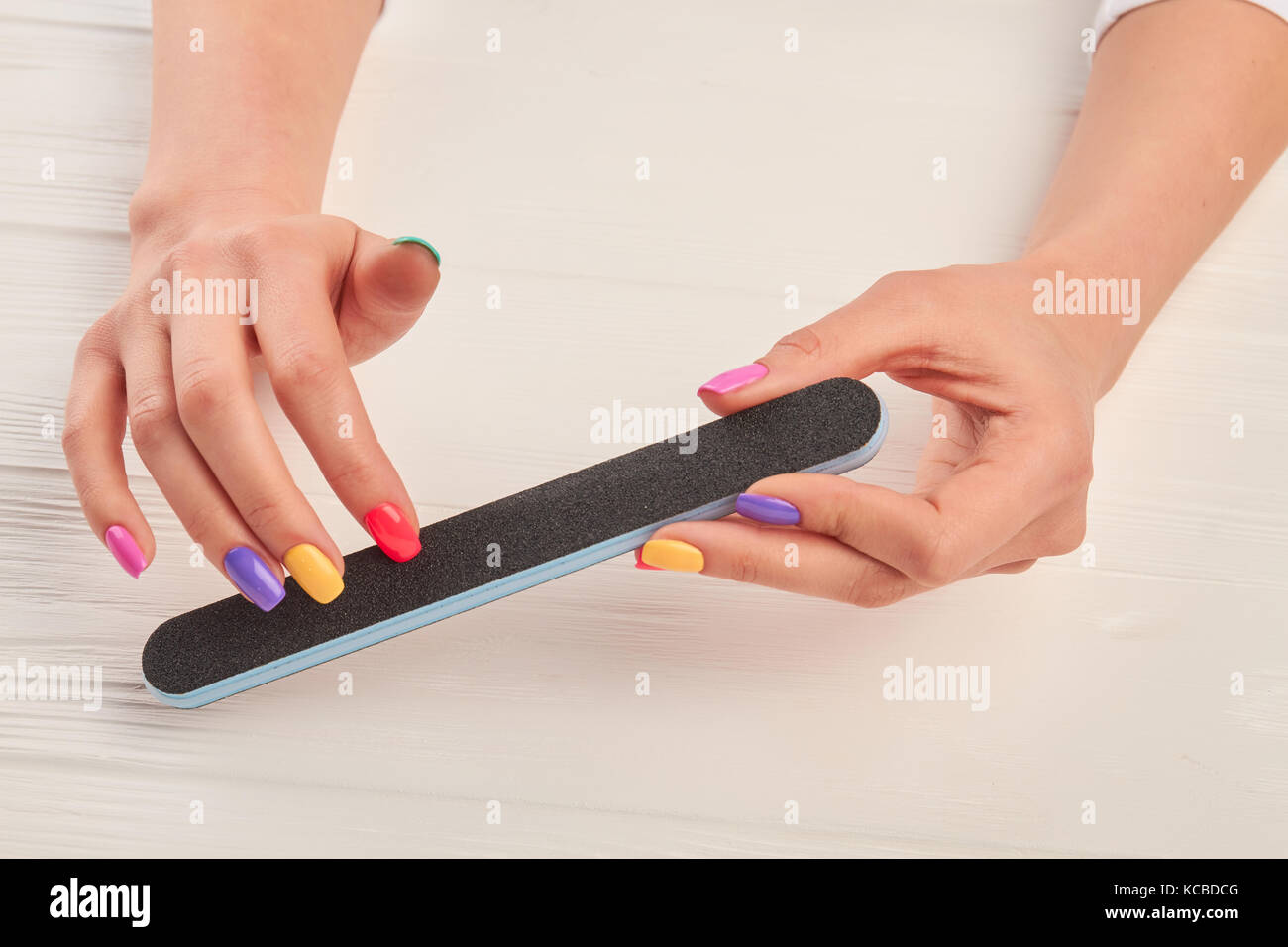 Female hands filing nails with nail file Stock Photo - Alamy