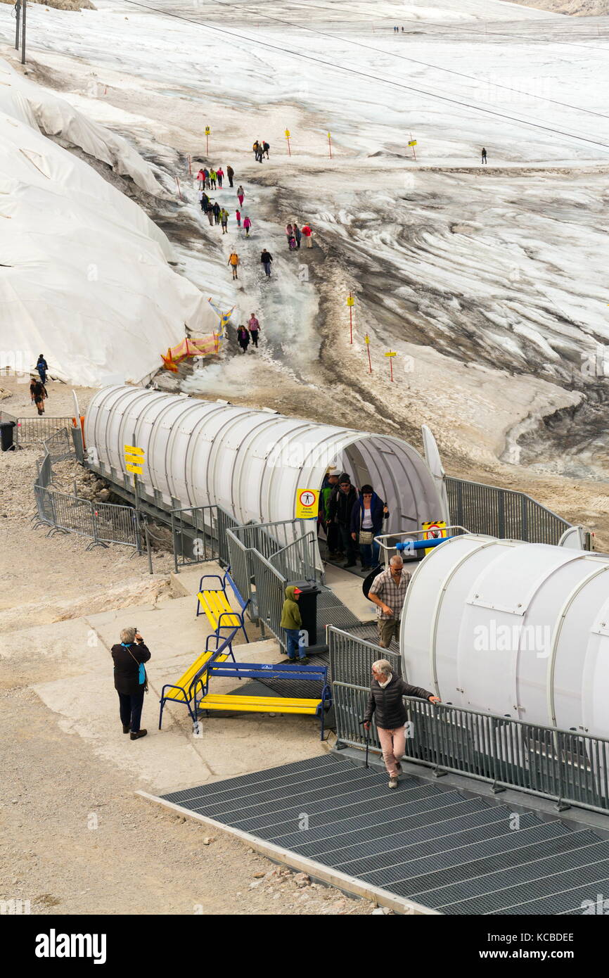 RAMSAU AM DACHSTEIN, AUSTRIA - AUGUST 17: Ski lift with people walking ...