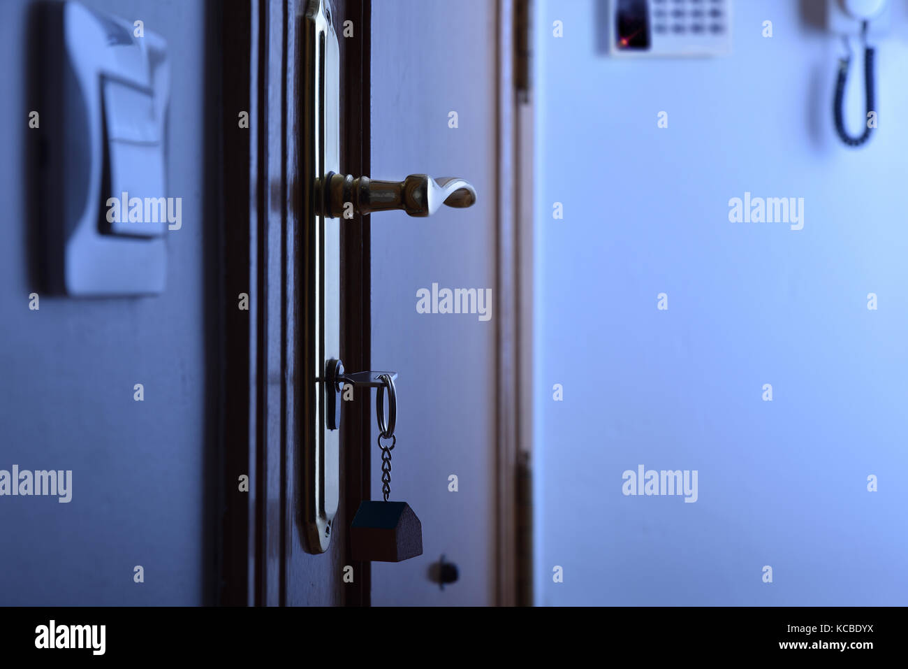 Entrance door with keys in the lock to the night. Concept of security ...