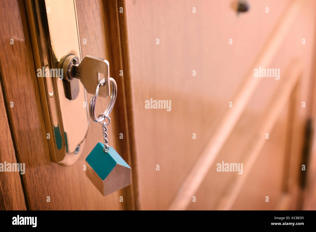 Entrance door detail of a house with keys in the lock. High angle view ...
