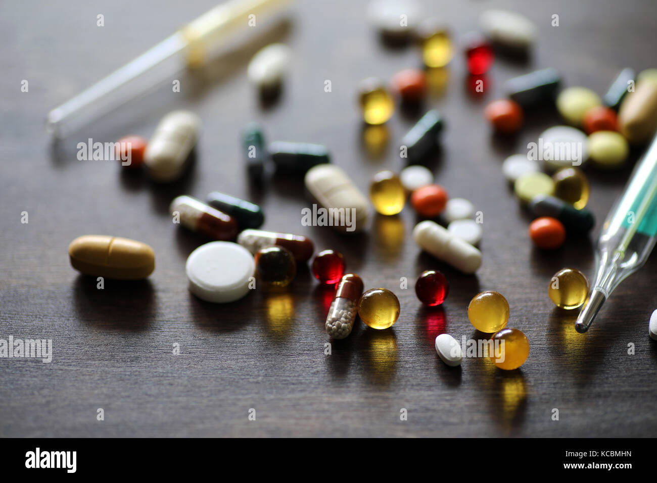 Medications and tablets on a wooden texture table Stock Photo - Alamy