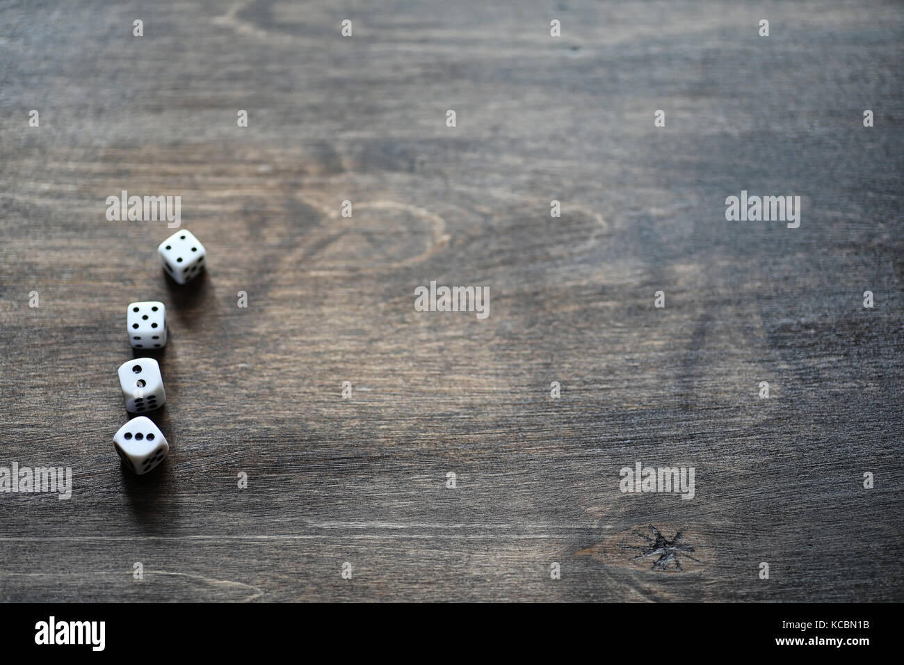 White dices on a brown wooden texture table Stock Photo - Alamy