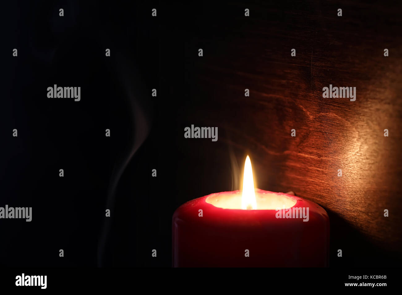 Burning candle flame in the dark Stock Photo - Alamy