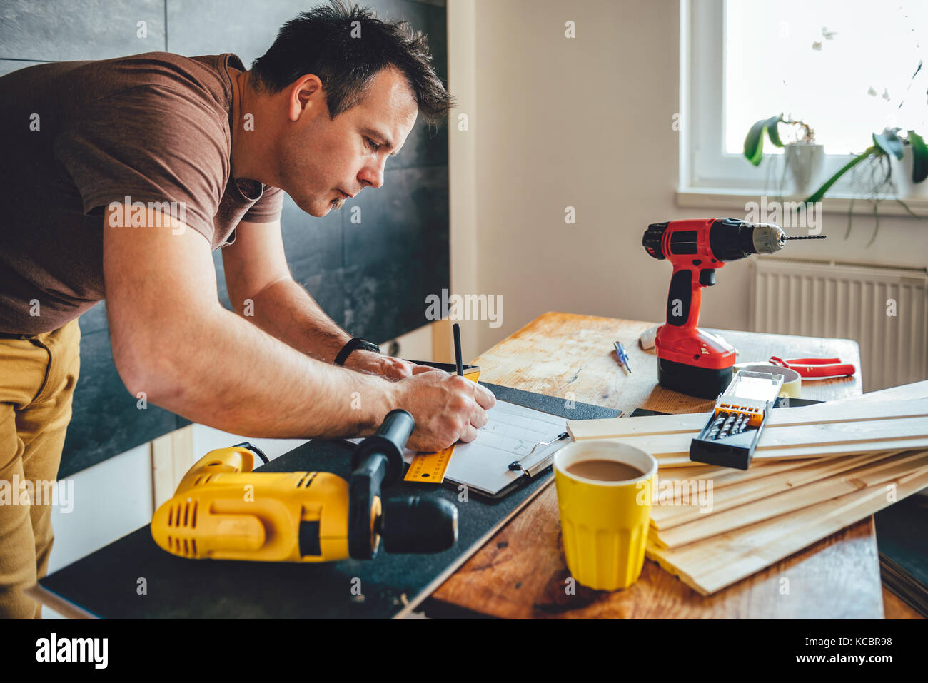 Man making draft plan using pencil on the table with tools Stock Photo ...