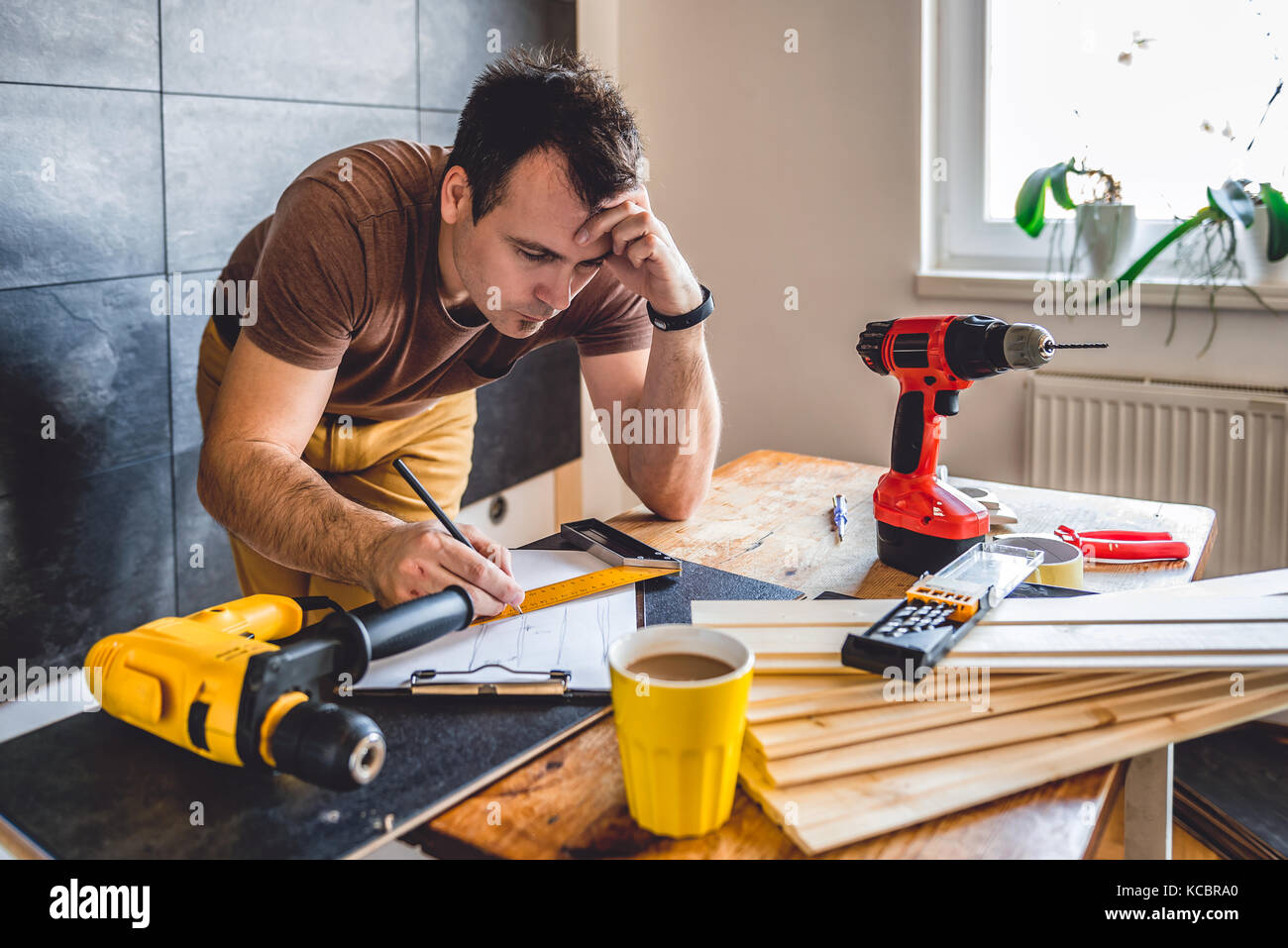 Man making draft plan using pencil on the table with tools Stock Photo ...