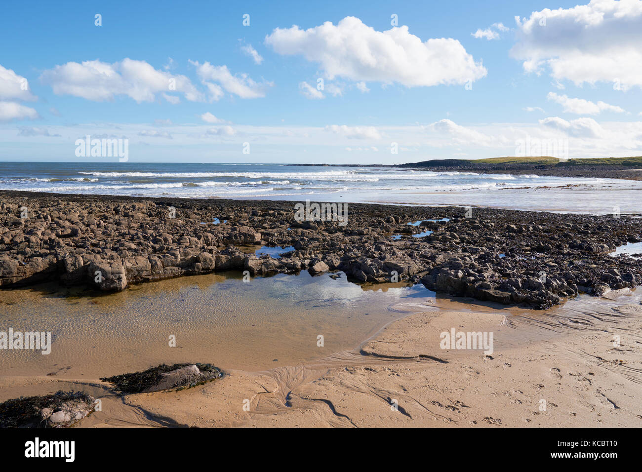 The rocky shore and sandy beach at Embleton Bay, Northumberland ...