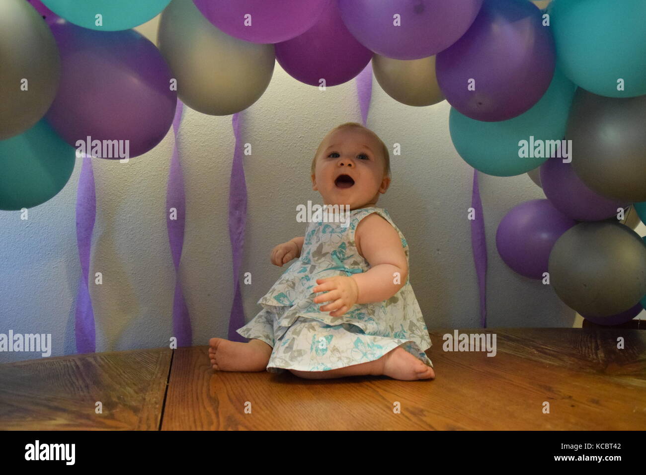 Baby under balloons Stock Photo - Alamy