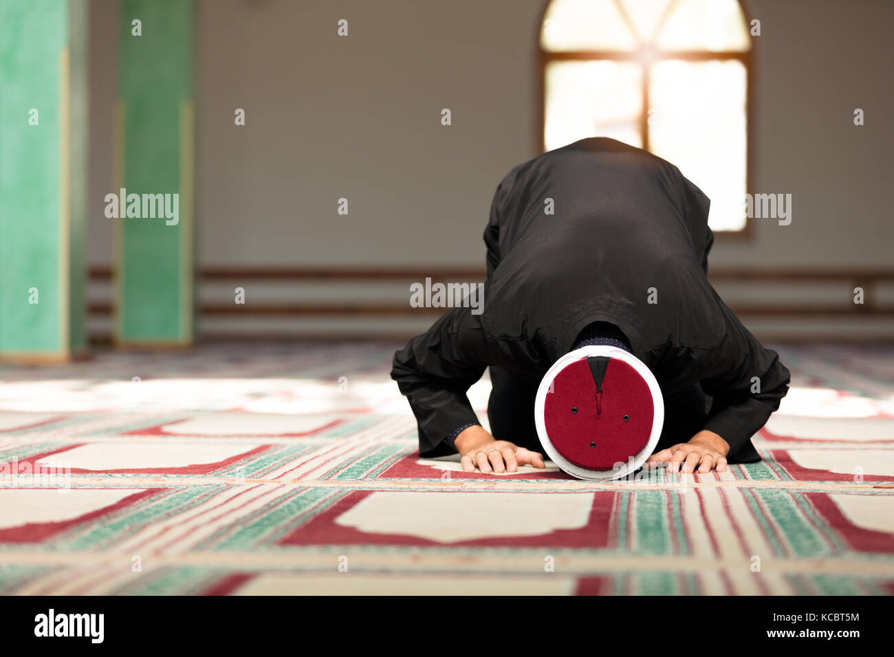 Young Imam praying inside of beautiful mosque Stock Photo - Alamy