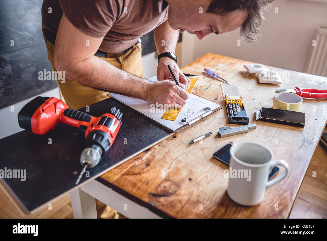 Man making draft plan using pencil on the table with tools Stock Photo ...