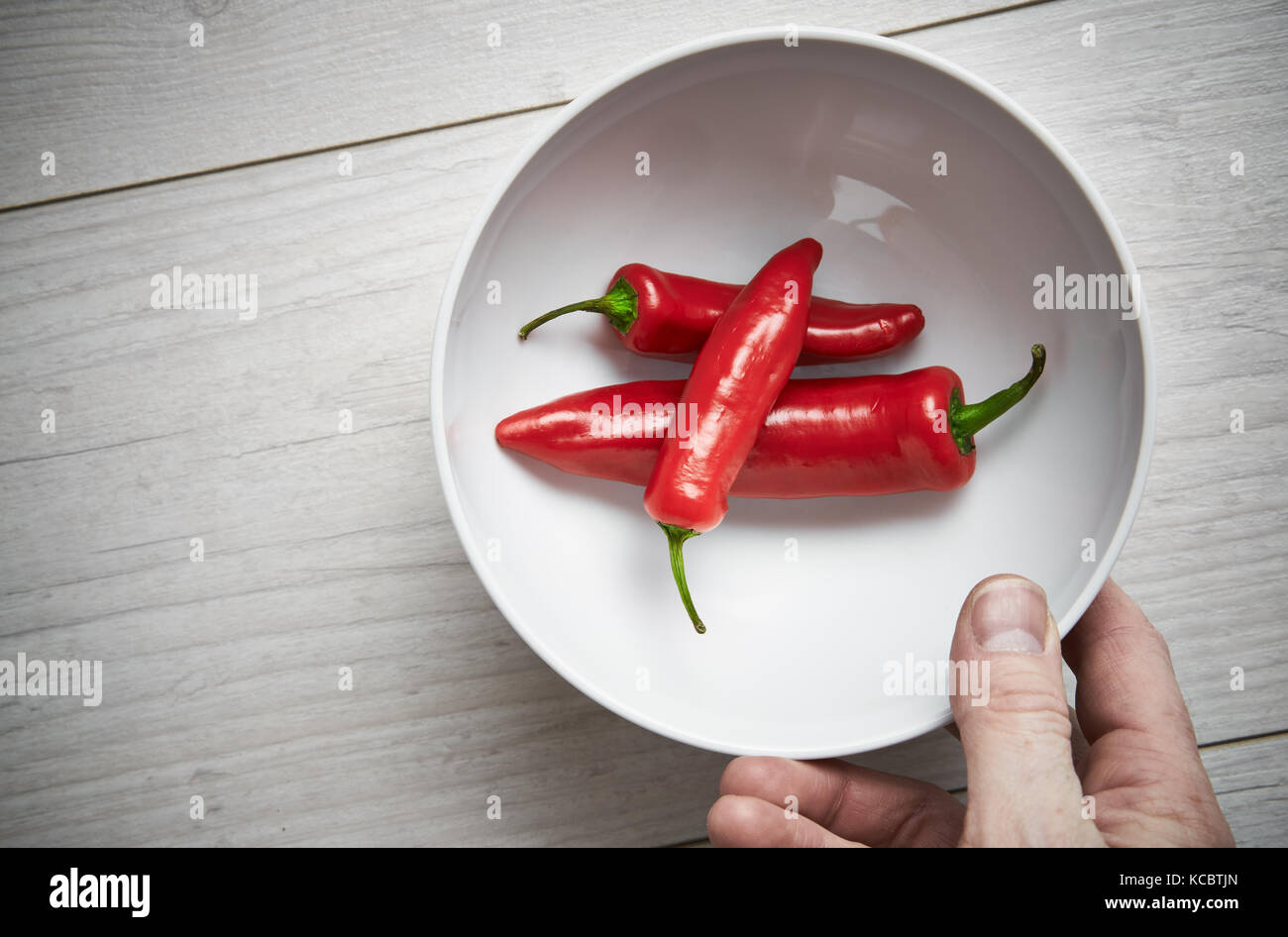 Mans hand picking chili peppers hi-res stock photography and images - Alamy