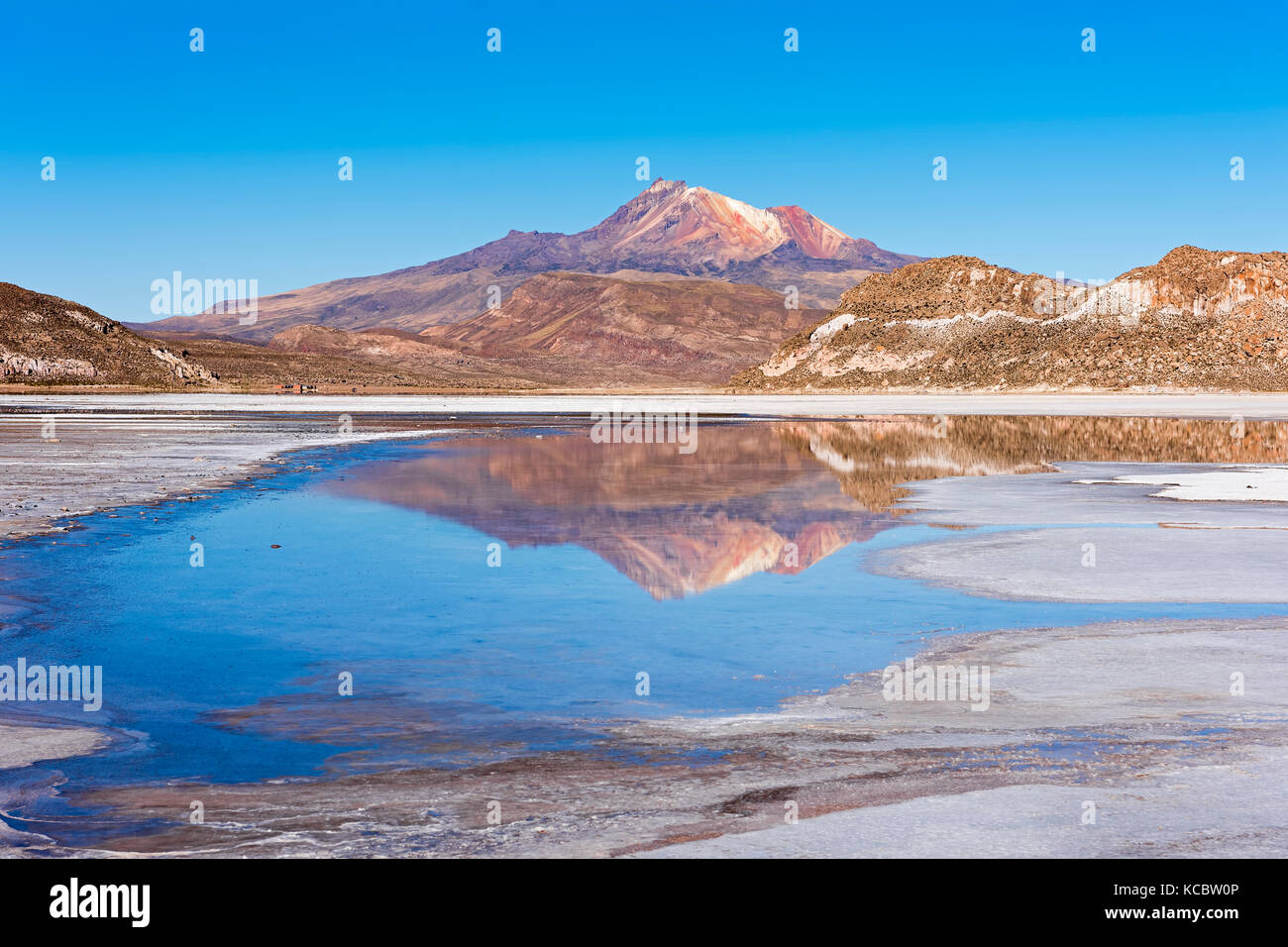 Volcano Cerro Tunupa with reflection in the Salar de Uyuni, Altiplano ...