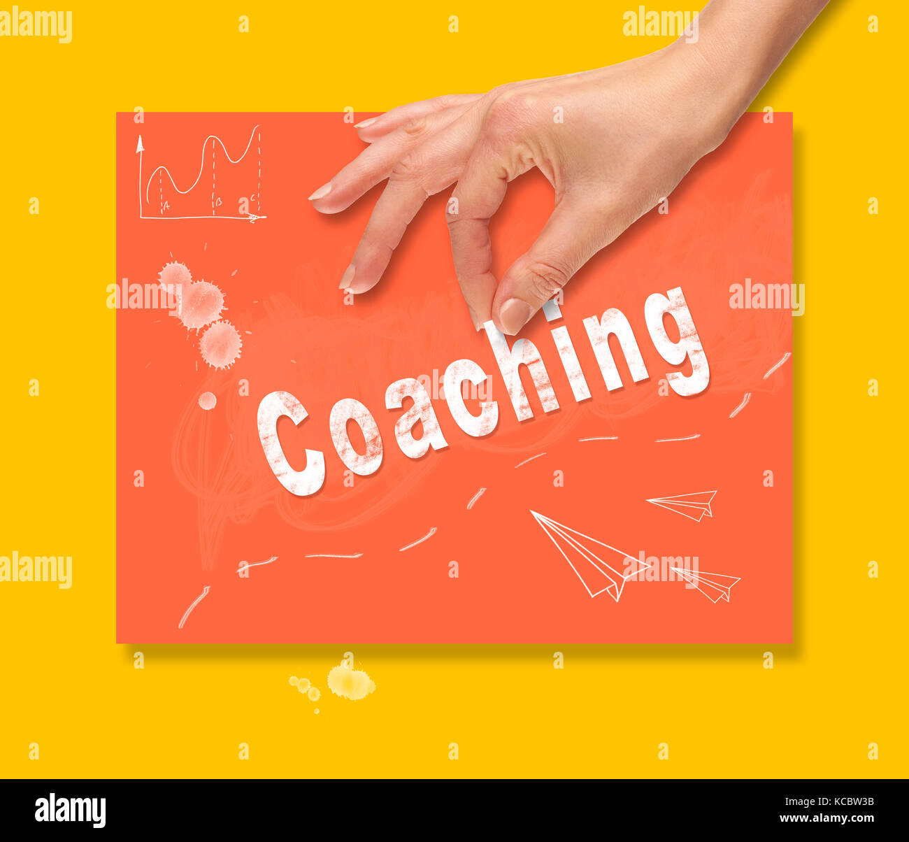 A hand picking up a Coaching concept on a colorful drawing board Stock ...