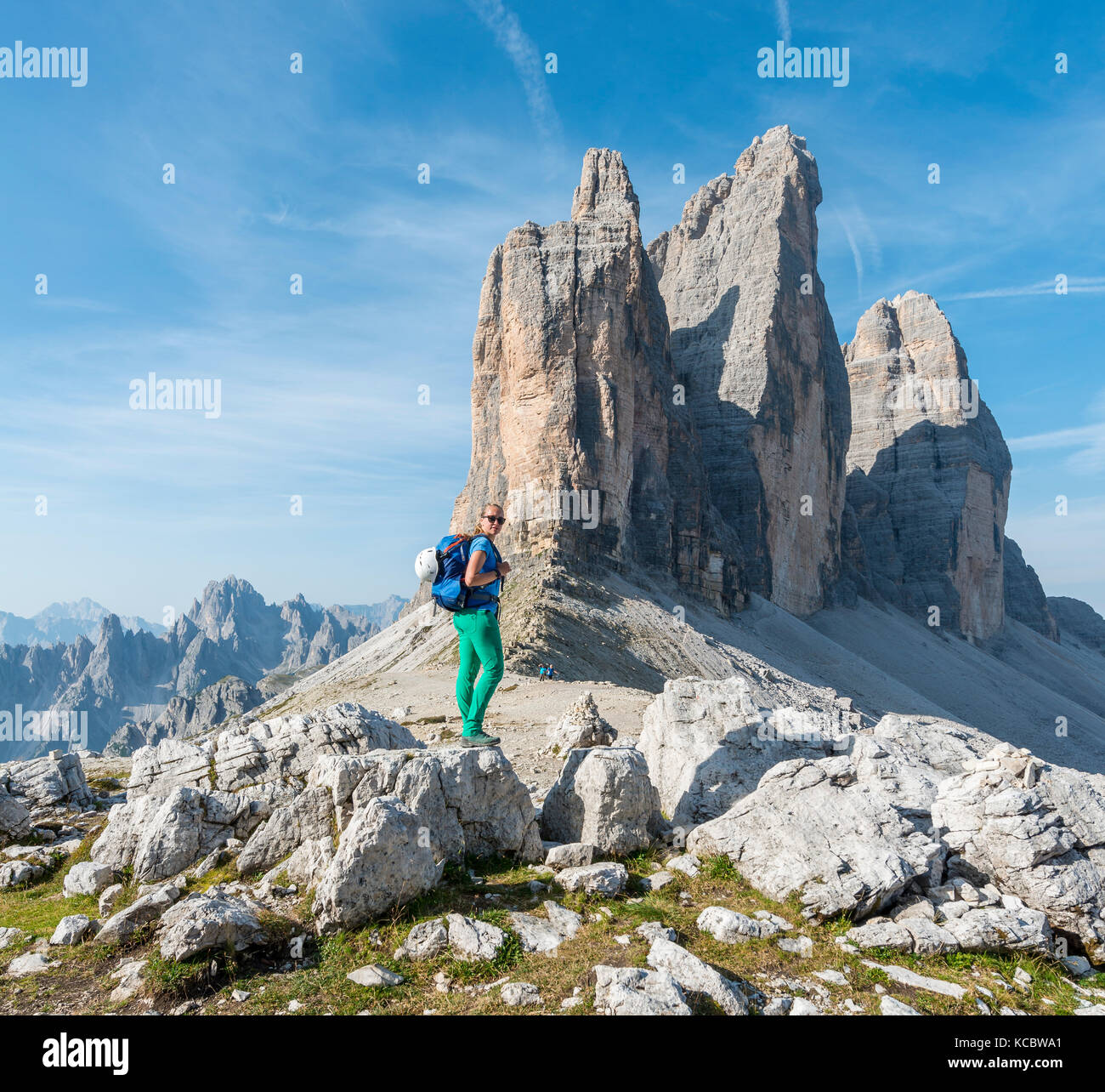 Hiker at the saddle of the Paternsattel, North faces of the Three Peaks ...