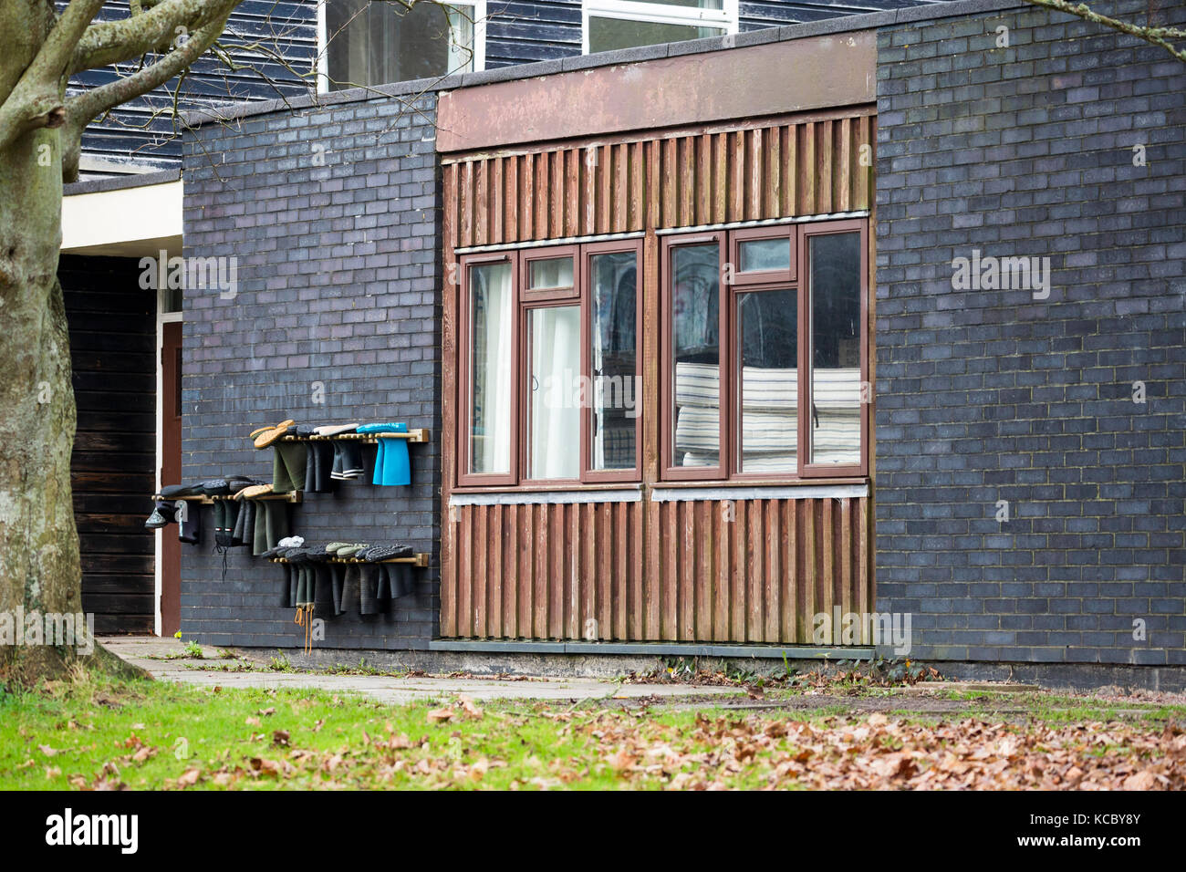 wellington boots in rack outside building Stock Photo - Alamy