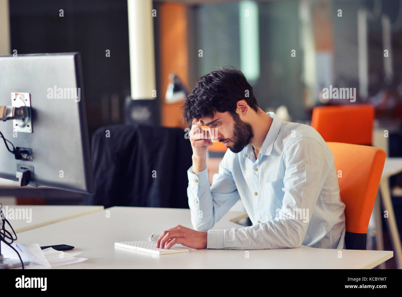 young business man working on desktop computer at his desk in modern ...