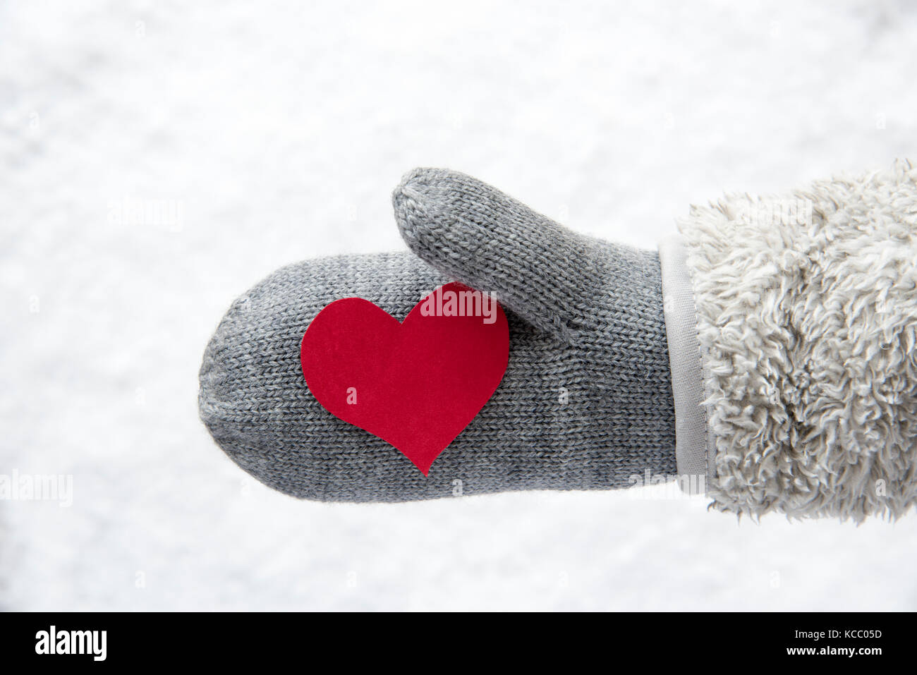 Wool Glove With Red Heart, Snow Stock Photo - Alamy