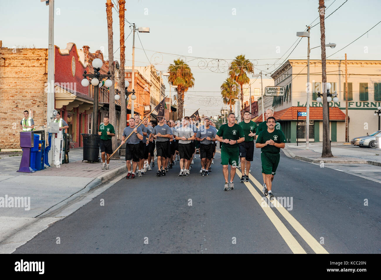 Law enforcement academy cadets running in formation through the streets ...