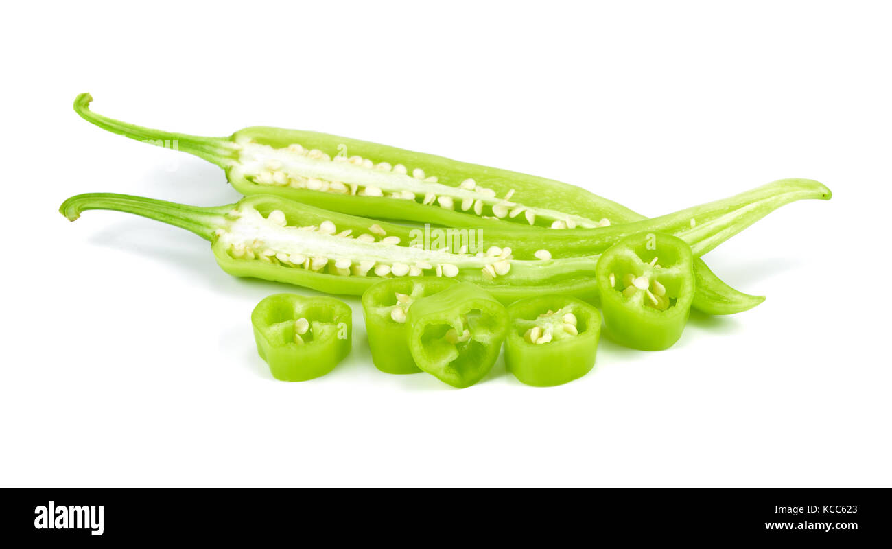 A pile chopped chilli peppers on a white background, sliced green bell ...