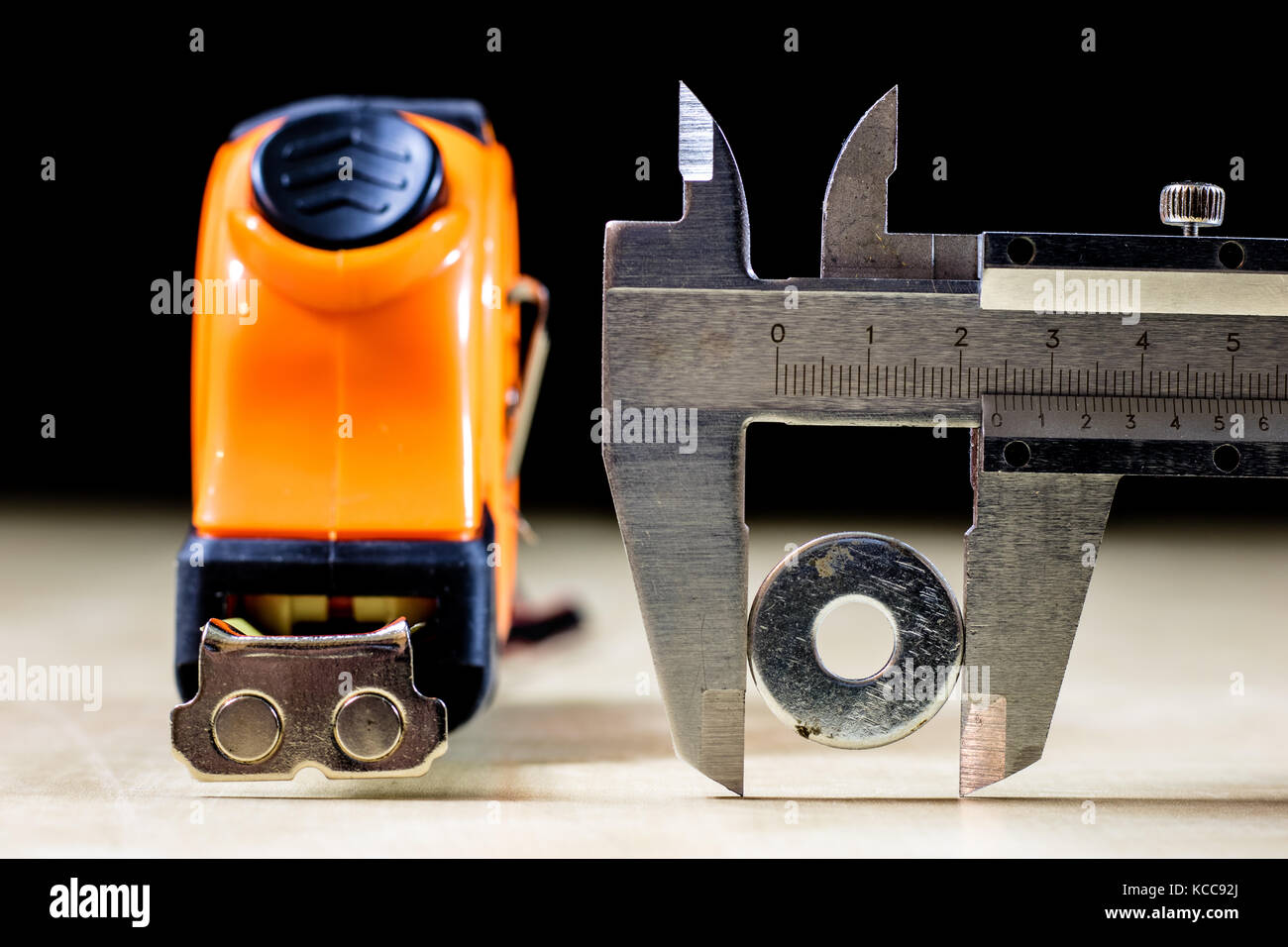 Old good caliper in hand while measuring the abdomen. Wooden table ...
