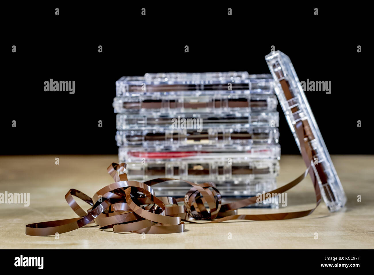 Cassette tape on a wooden table. Old good music from the 80's. Black ...