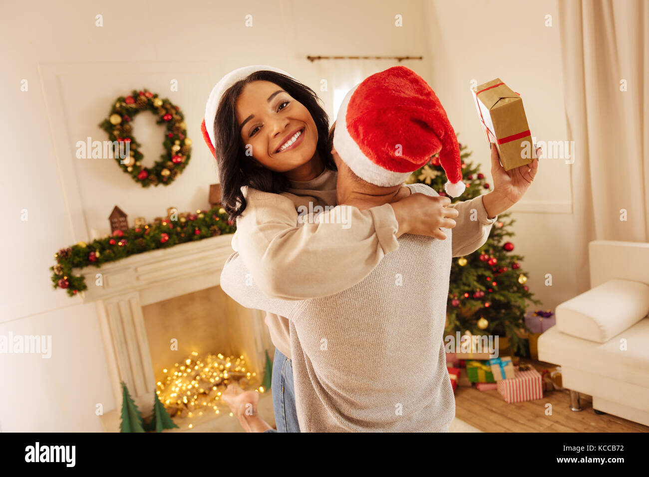 Happy woman thanking her husband for Christmas gift Stock Photo - Alamy