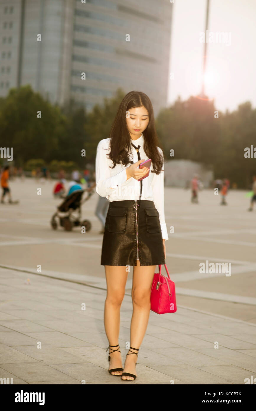 Women use a mobile phone in the night of the street Stock Photo - Alamy