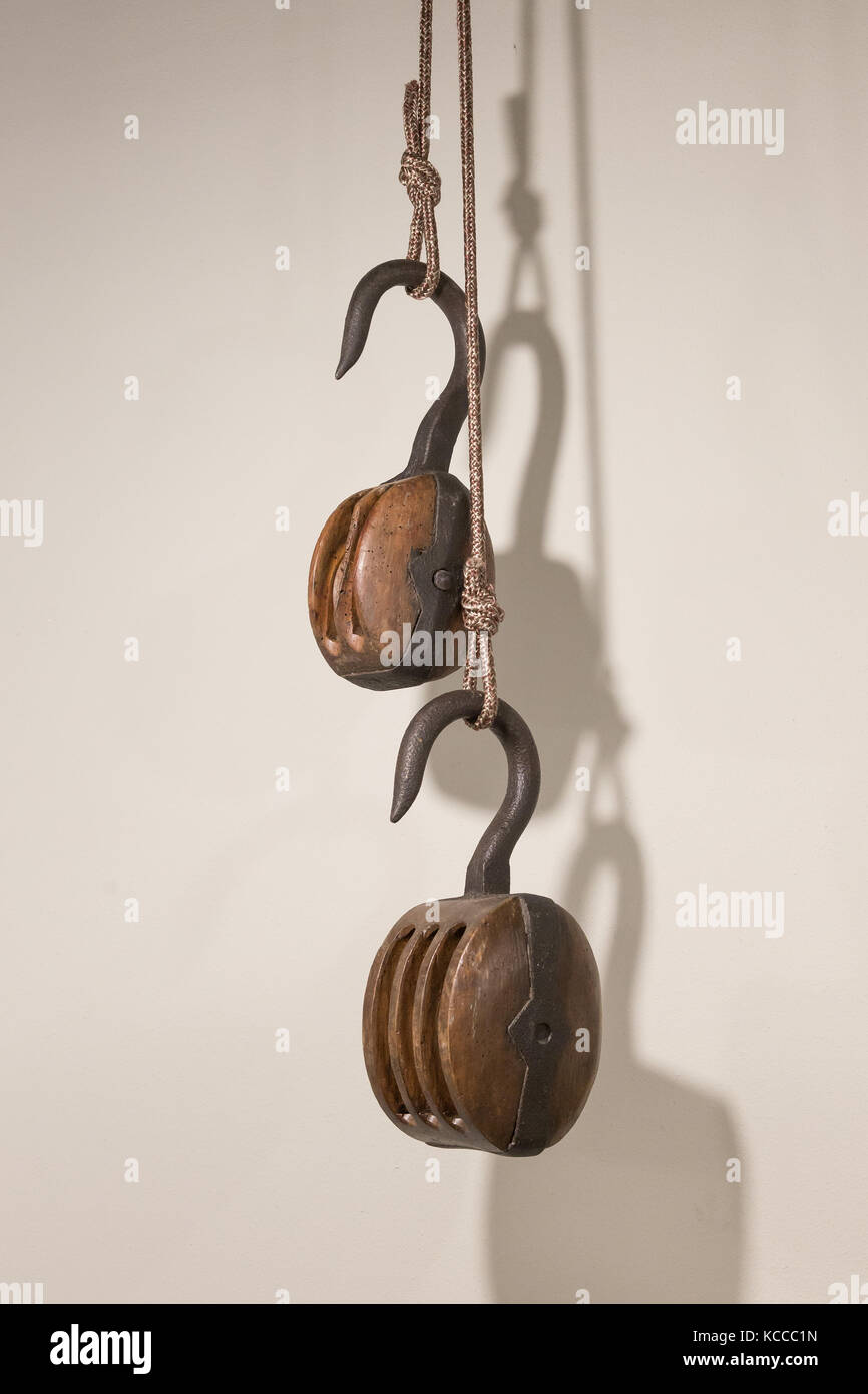 Old wooden pulley, isolated on a white wall Stock Photo - Alamy