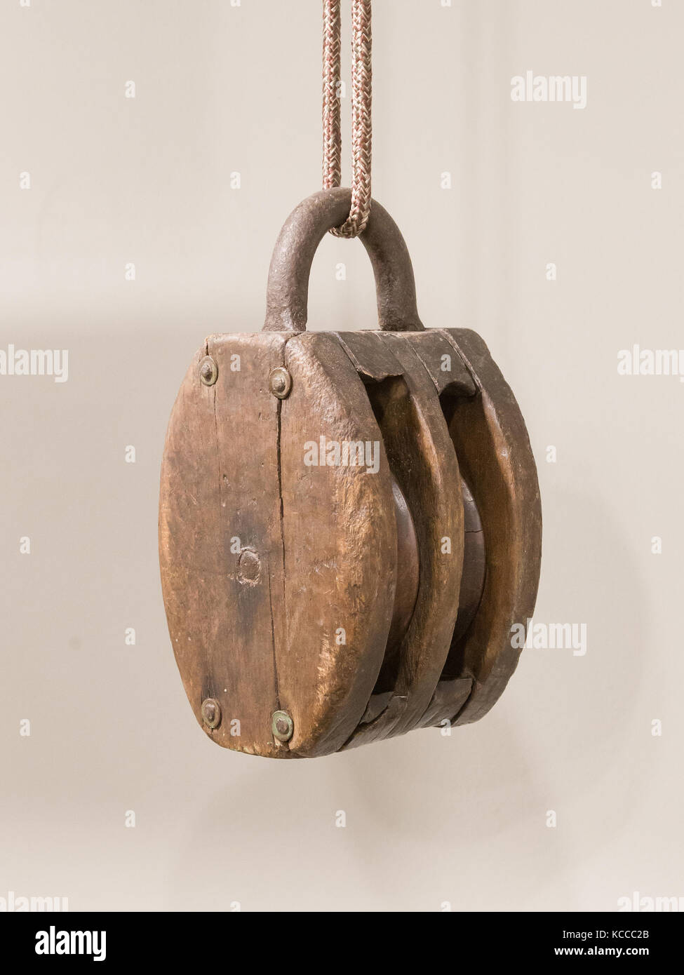 Old wooden pulley, isolated on a white wall Stock Photo - Alamy