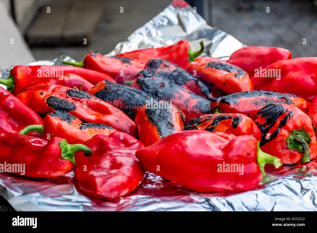 roasted red peppers on metal sheet cooke with aluminium foil under ...