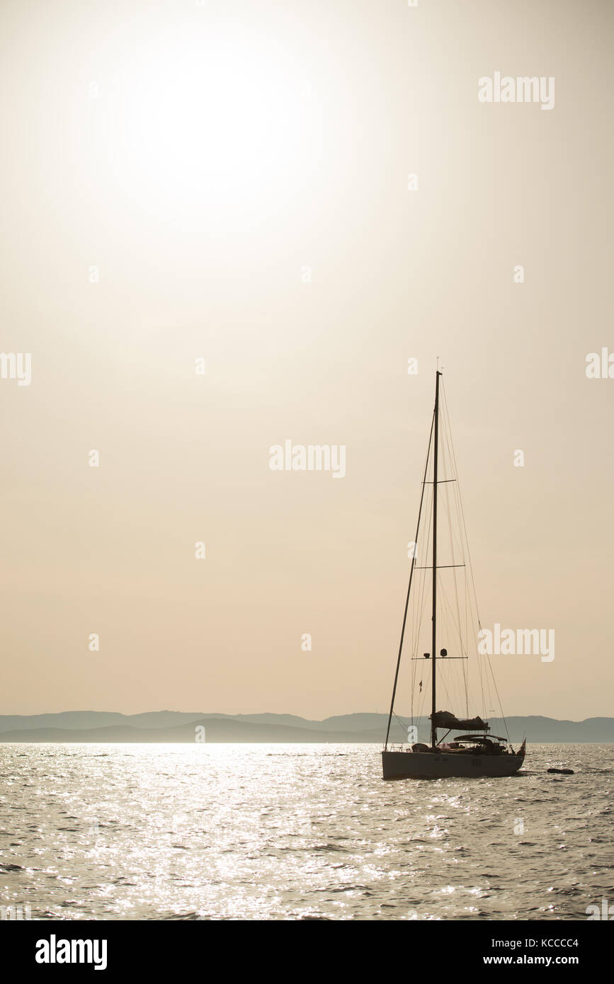 Silhouette of motor sailing yacht during sunset Stock Photo - Alamy