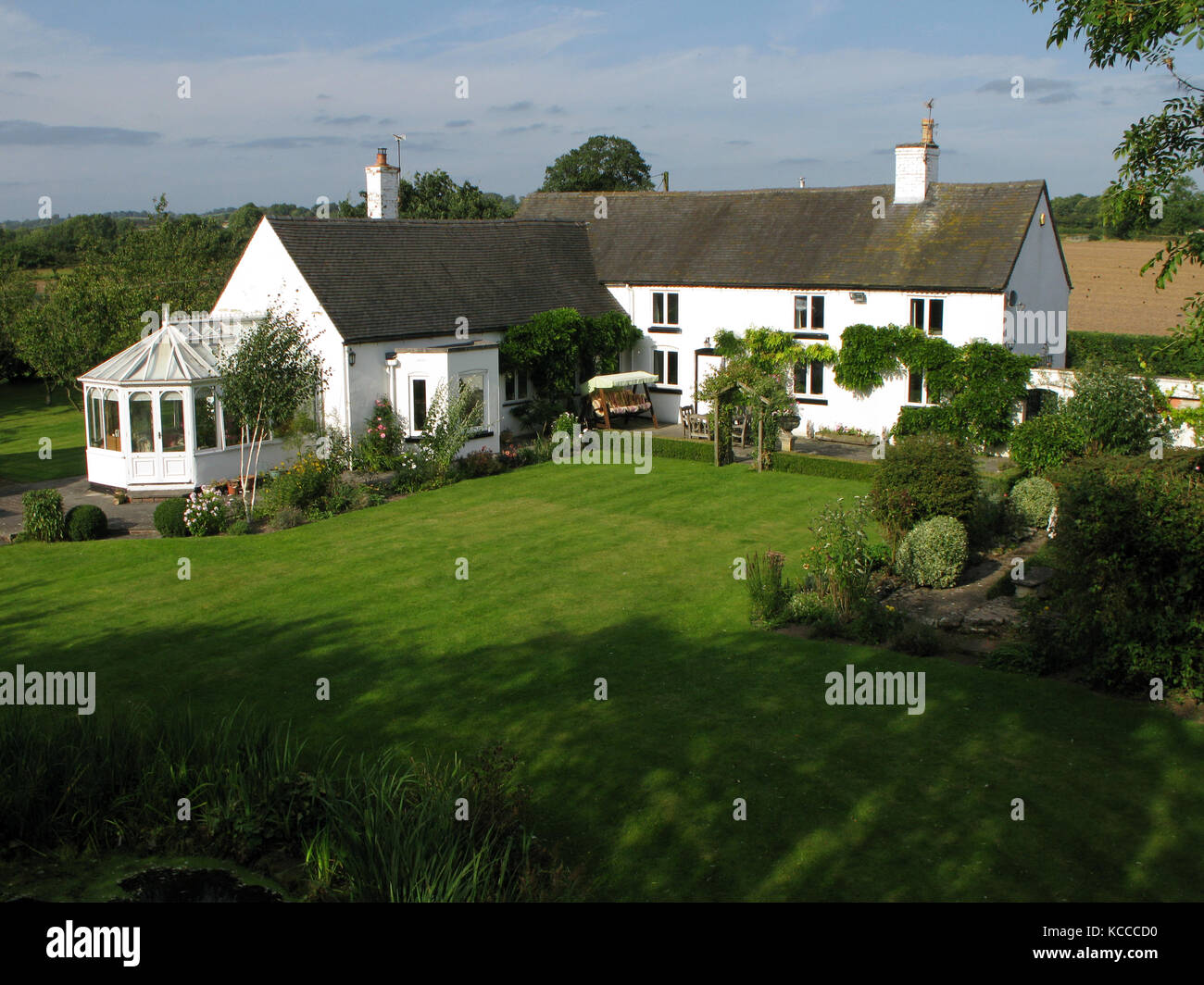 Elevated view of large white farmhouse with lawned garden Stock Photo ...