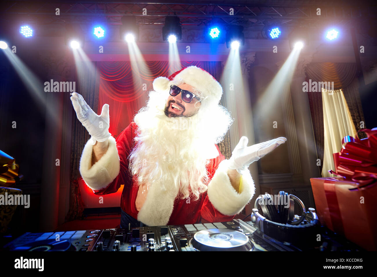 Funny Santa DJ mixes in the beams of light music Stock Photo - Alamy