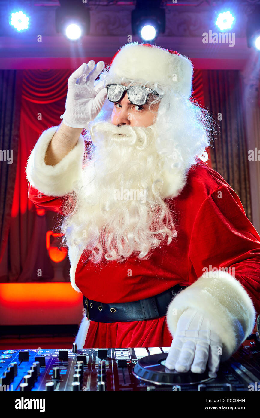 Funny Santa DJ mixes in the beams of light music Stock Photo - Alamy