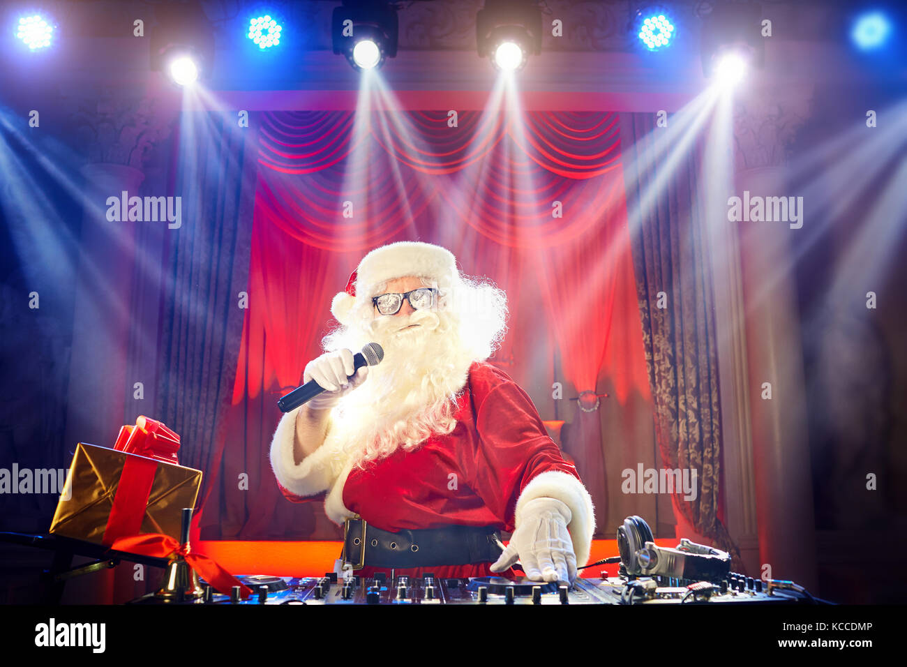 Funny Santa DJ mixes in the beams of light music Stock Photo - Alamy
