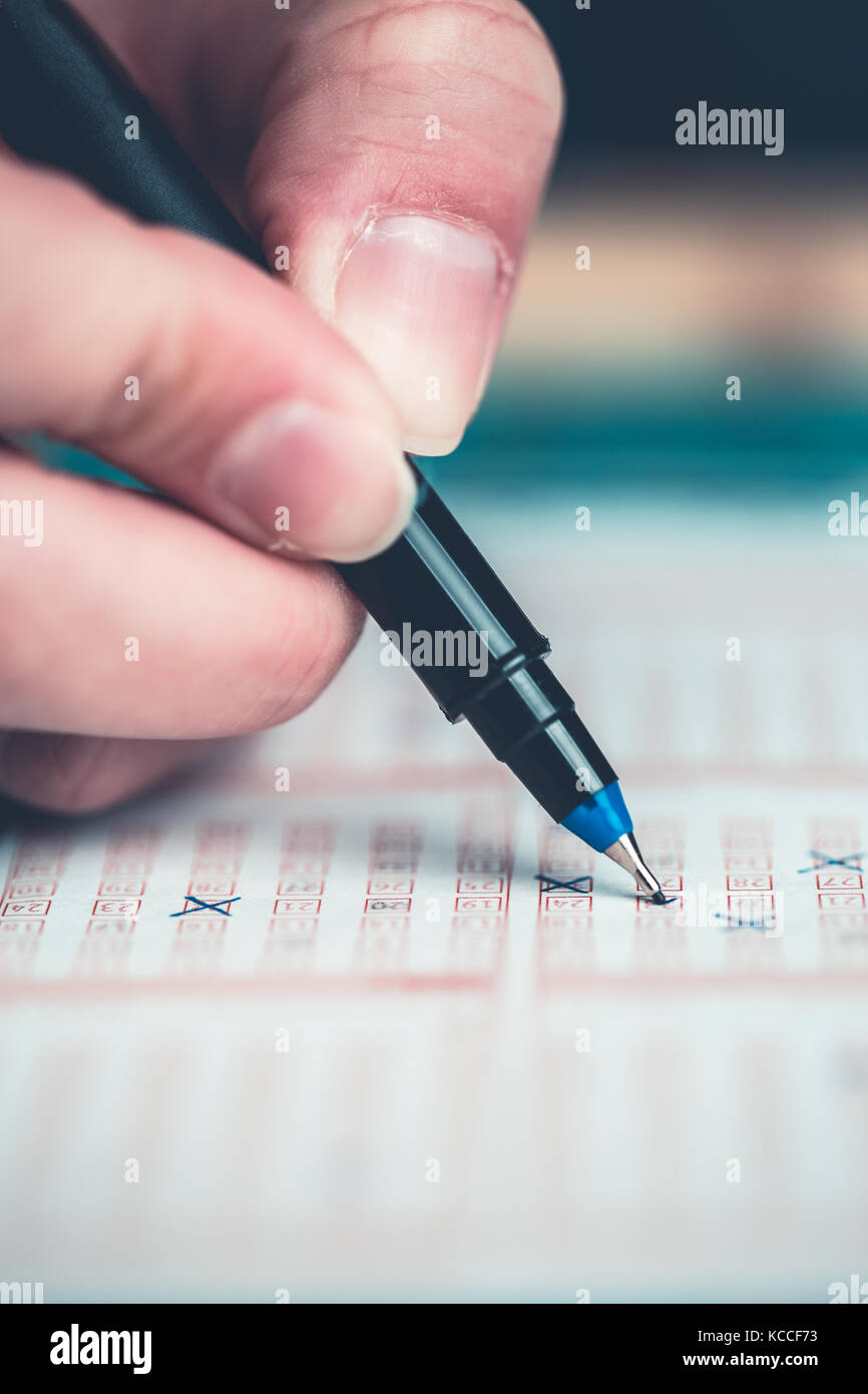 Picture of hand with pen and lottery ticket Stock Photo - Alamy