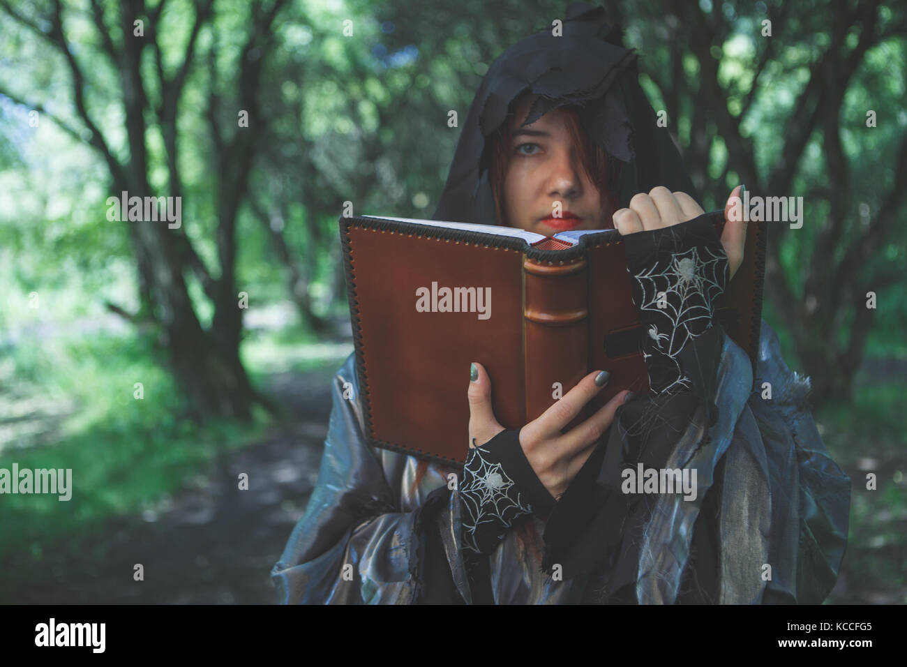 Photo of witch with book Stock Photo - Alamy