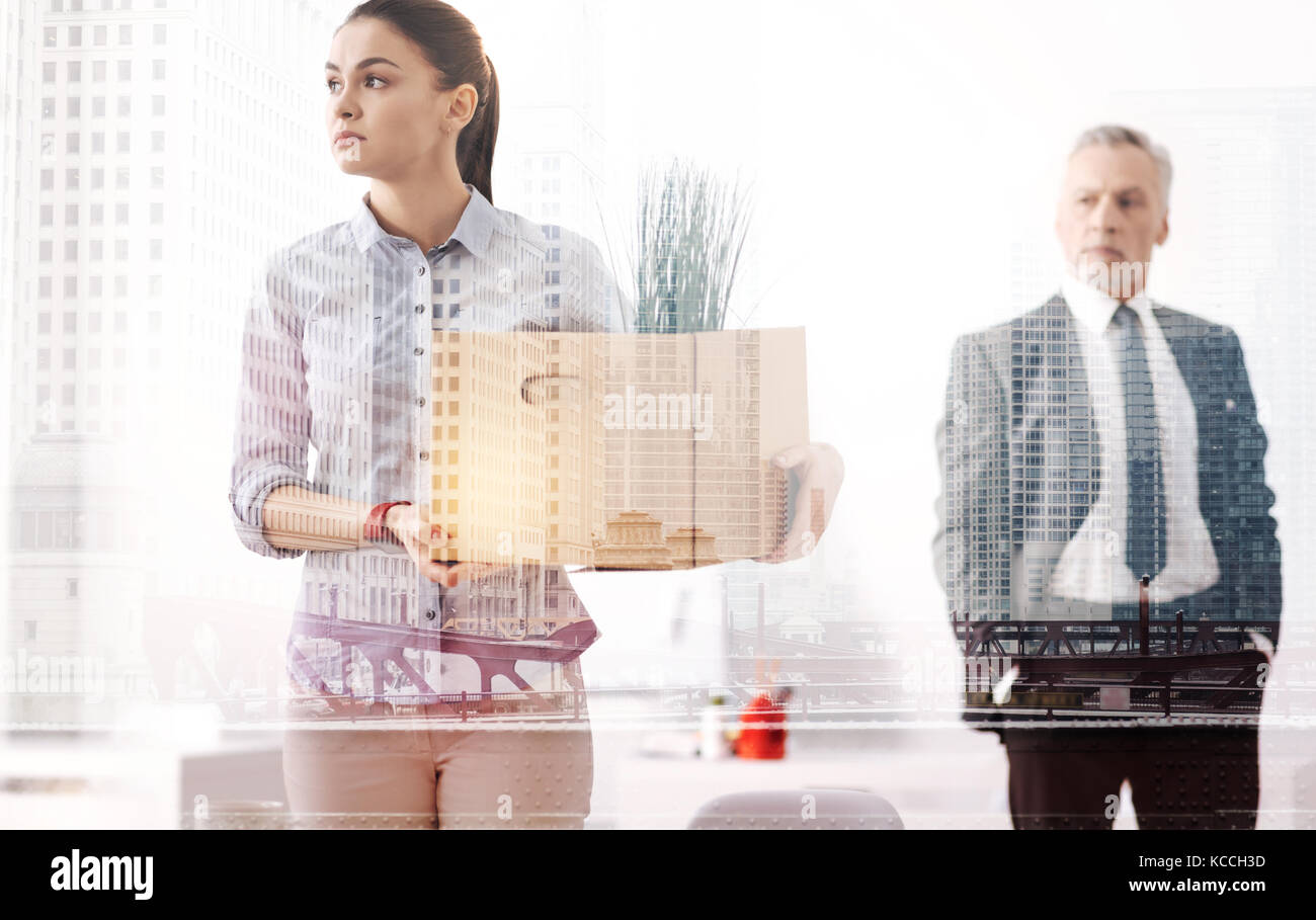 Sad unemployed woman standing in the office with her belongings Stock ...