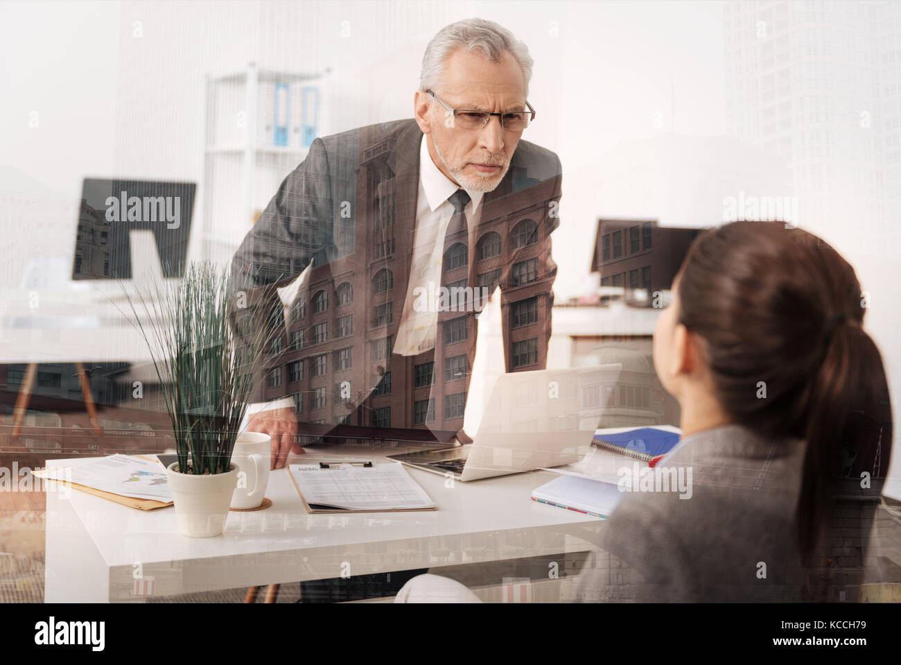 Strict boss having prejudices against his female office worker Stock ...
