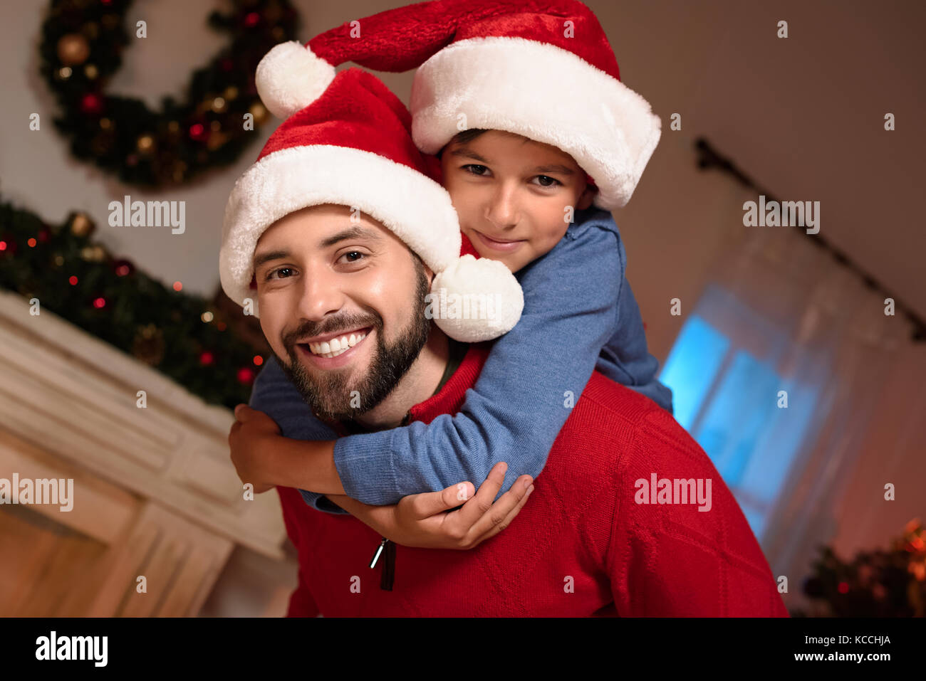 father and son in santa hats Stock Photo - Alamy