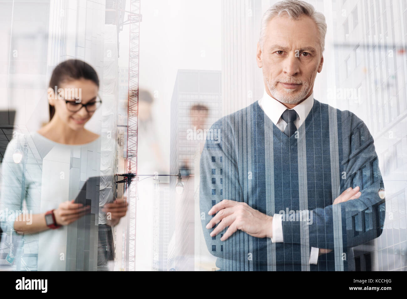 Confident adult male office worker standing in the office Stock Photo ...