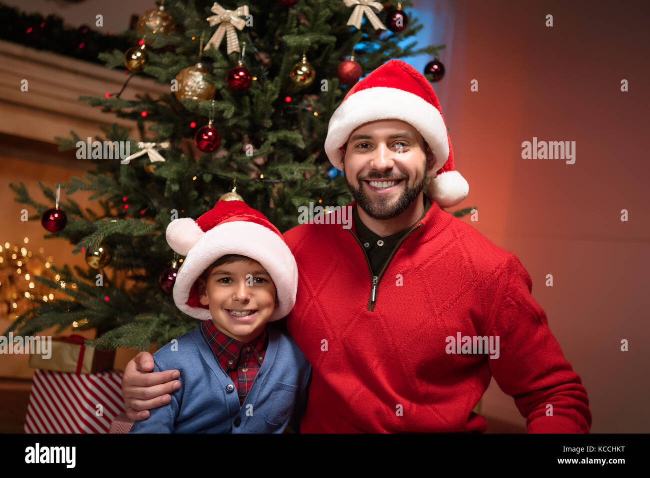 father and son in santa hats Stock Photo - Alamy