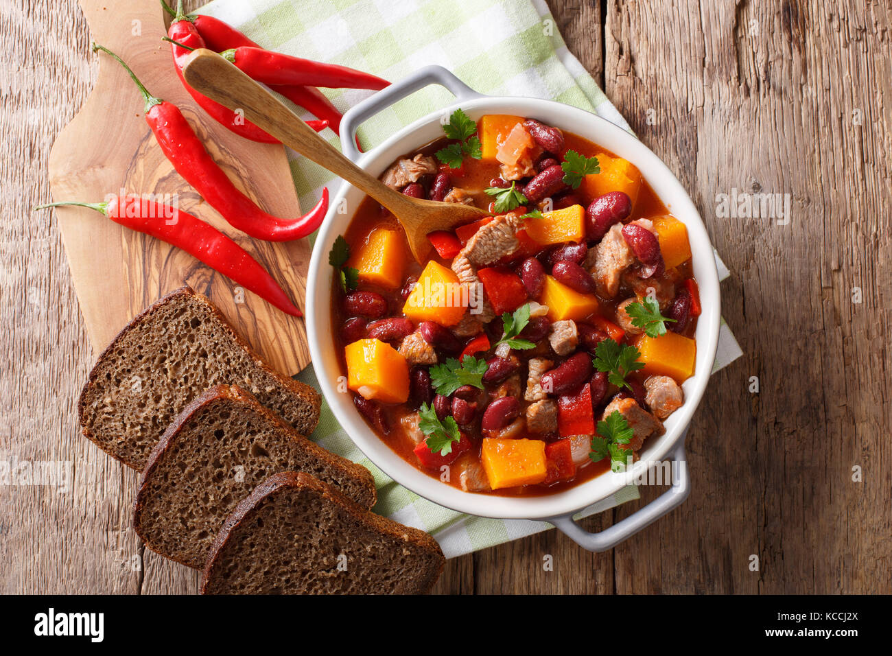 Stew with beef, pumpkin, red beans, tomatoes and chilli close-up in a ...