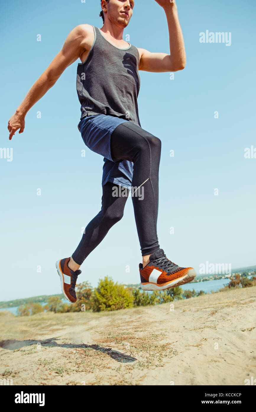 Running sport. Man runner sprinting outdoor in scenic nature. Fit ...