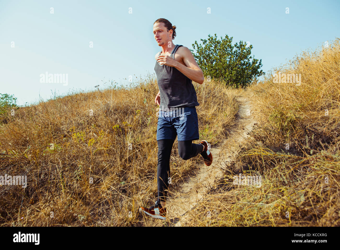 Running sport. Man runner sprinting outdoor in scenic nature. Fit ...